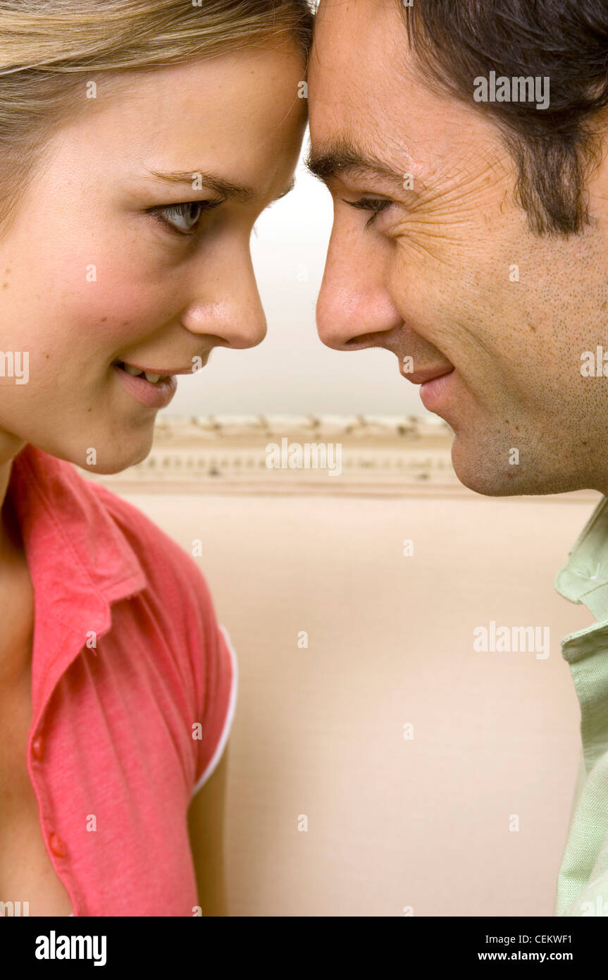 Couple looking into each others eyes, foreheads touching Stock Photo ...