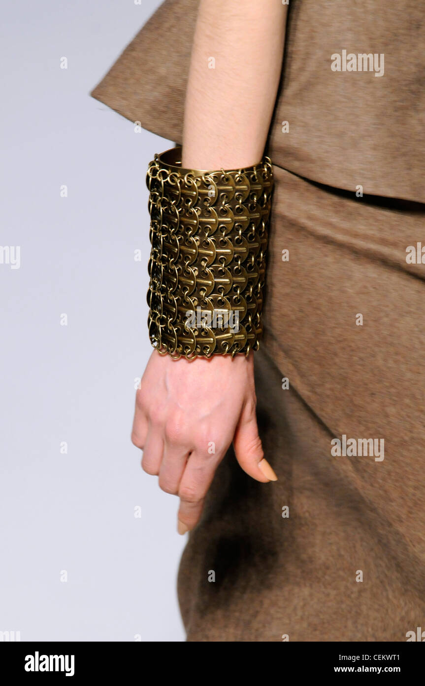 Model wearing a chunky brass wrist cuff Stock Photo - Alamy