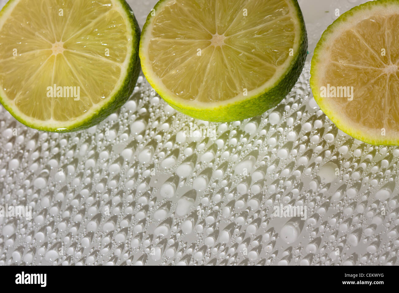 Lime with water drops on white Stock Photo - Alamy