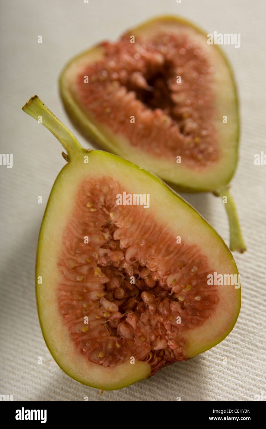 A fresh fig cut in half on a white background Stock Photo - Alamy