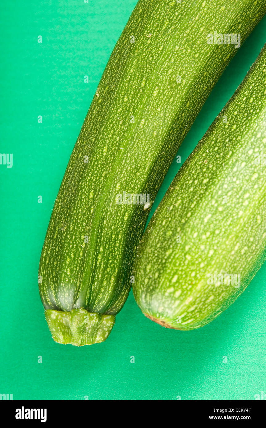 Two courgettes on a soft green background Stock Photo - Alamy