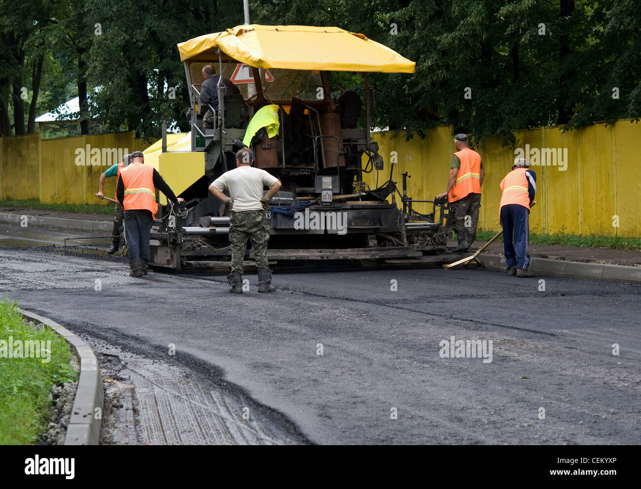 asphalt spreader is used to place the first layer of asphalt on a city ...