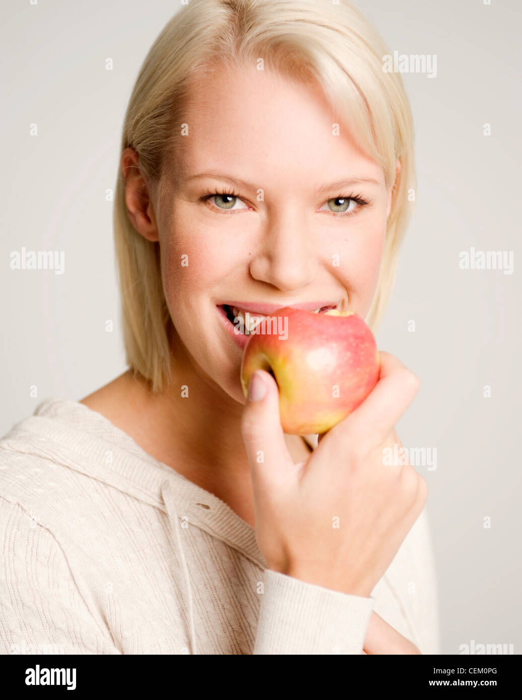 Female biting into an apple Stock Photo - Alamy