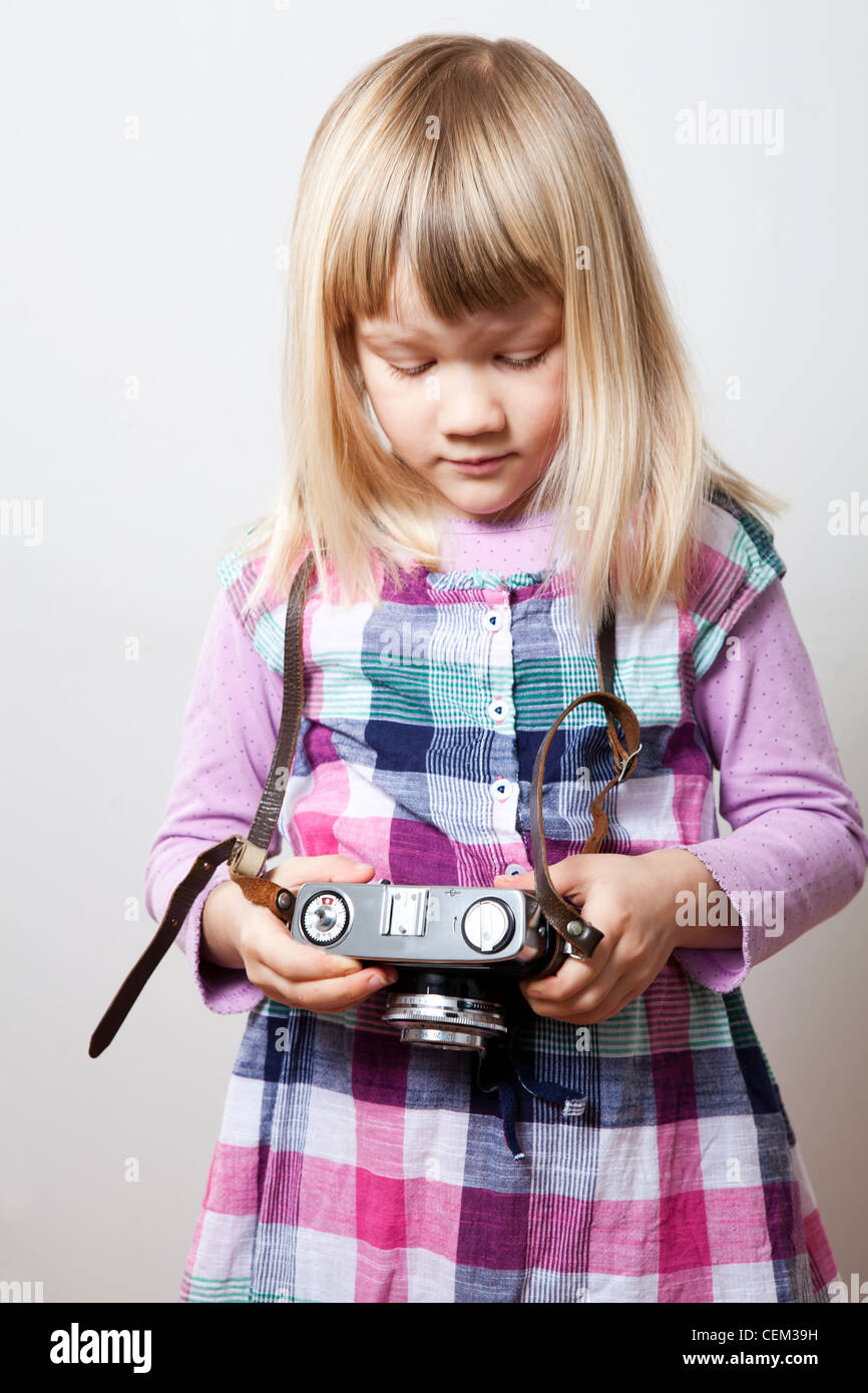 Little girl with a vintage camera. Studio shot Stock Photo - Alamy