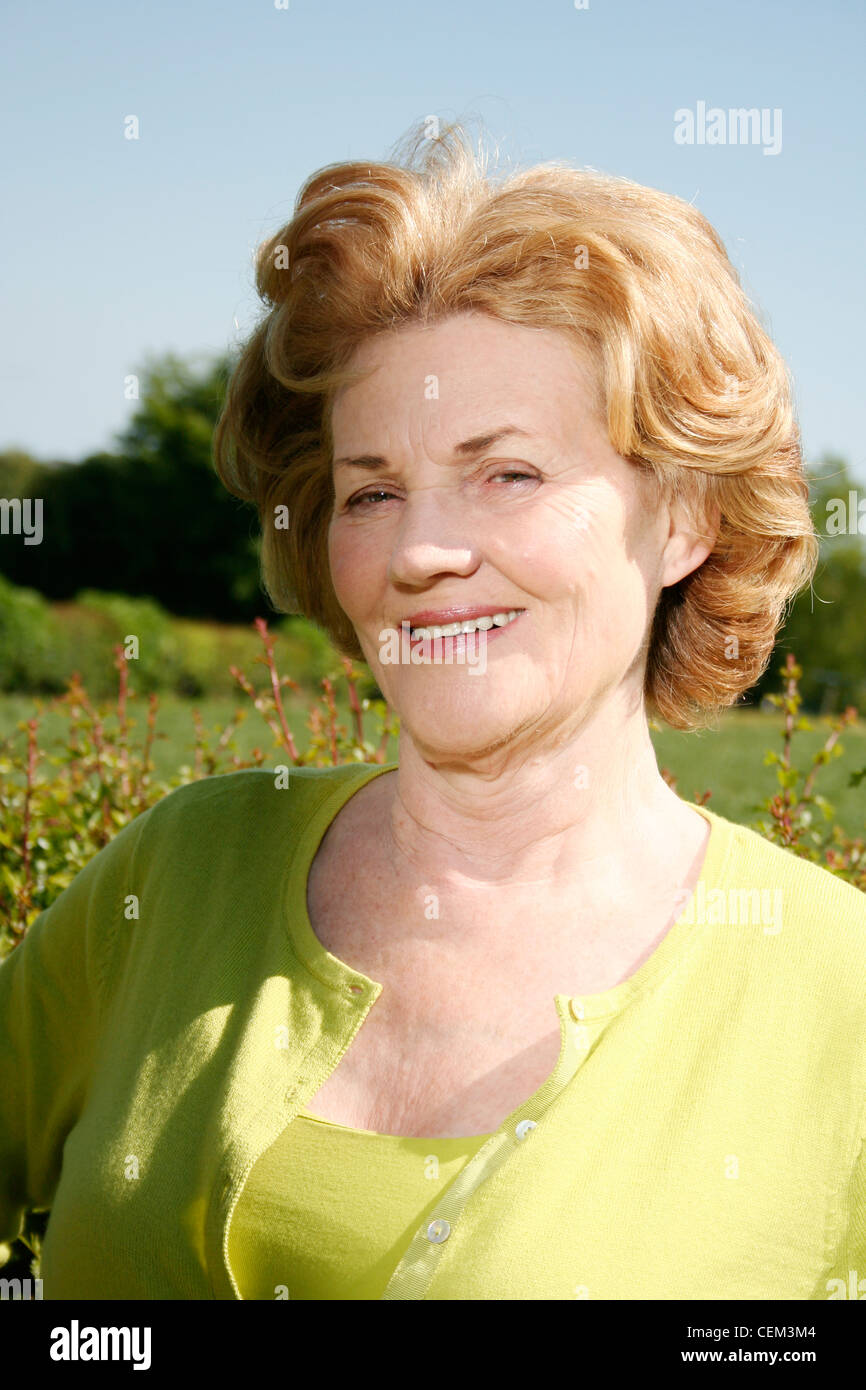 Female with short fair hair, wearing a green top and cardigan, smiling ...