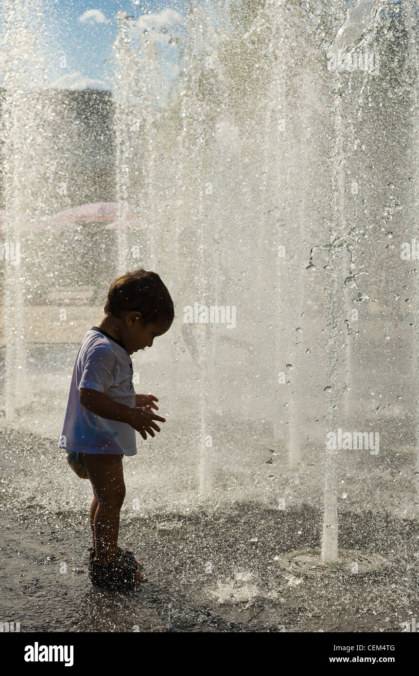 Silhouette of boy in splash park Stock Photo - Alamy