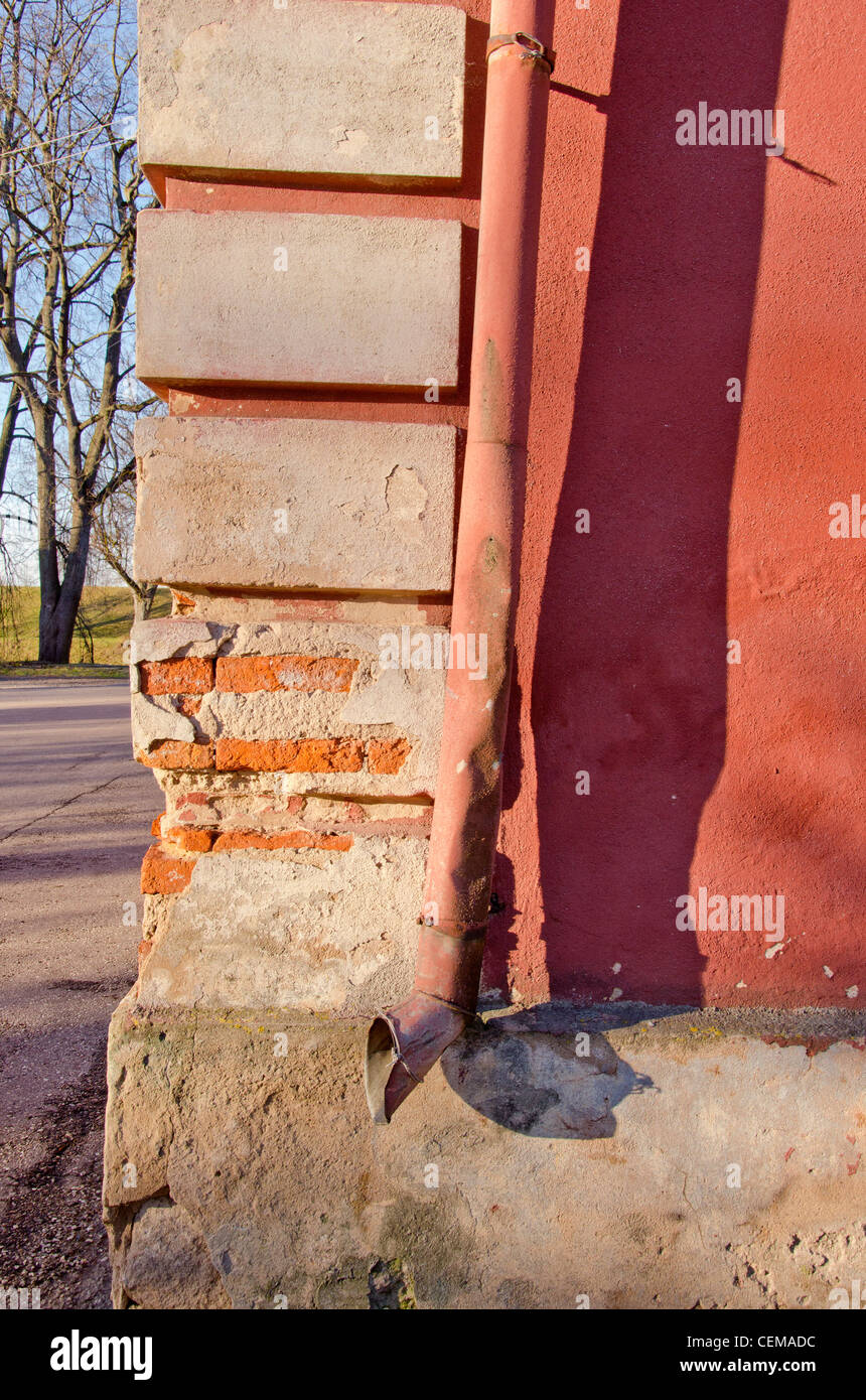 Old crumbling brick house corner wall closeup and rainwater pipe Stock ...