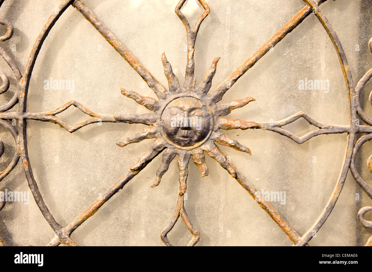 Closeup of decorative metal gate. Sun is shown in middle Stock Photo ...