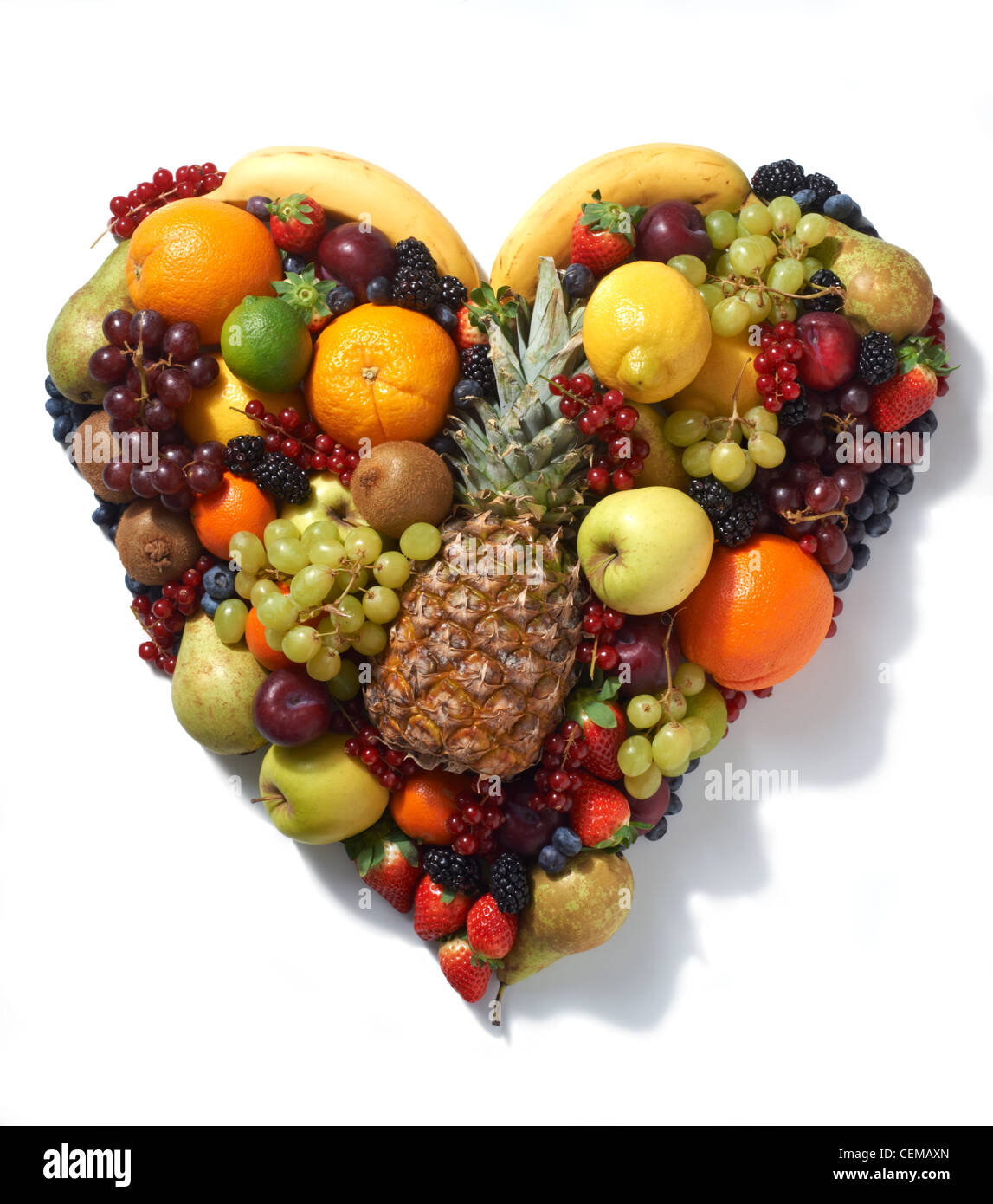 Overhead view of various types of fruit in heart shape on white ...