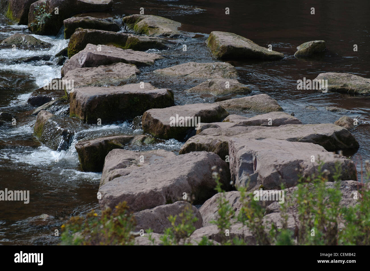shallow water running over rocks in river Stock Photo - Alamy