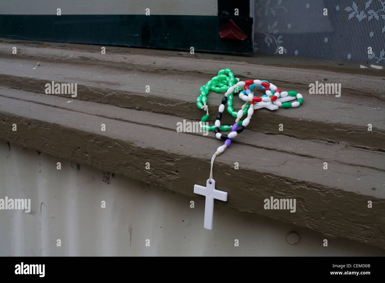 A colorful plastic rosary with crucifix on a window ledge Stock Photo ...