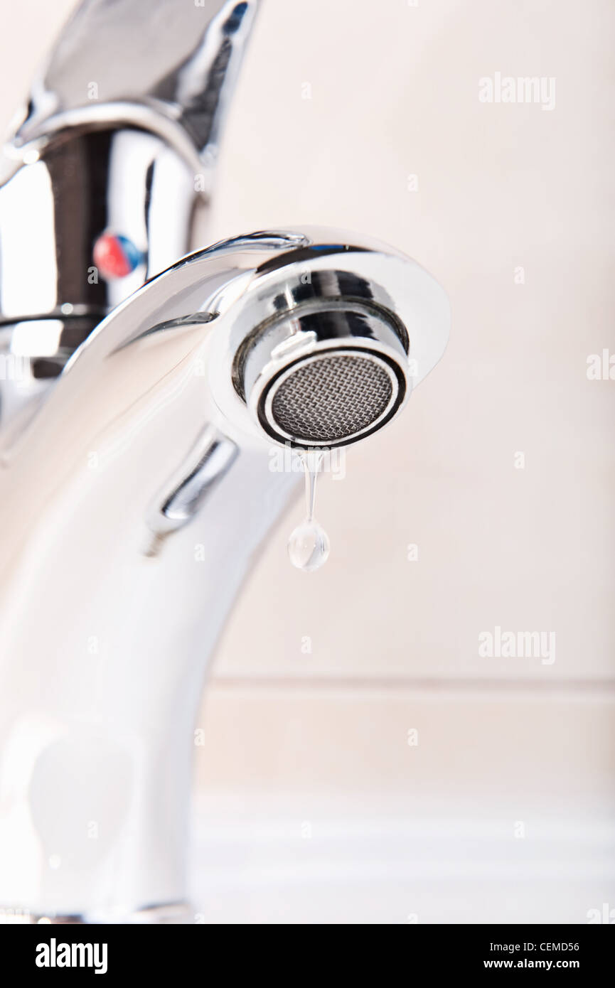 Modern faucet closeup with cute water drop Stock Photo - Alamy