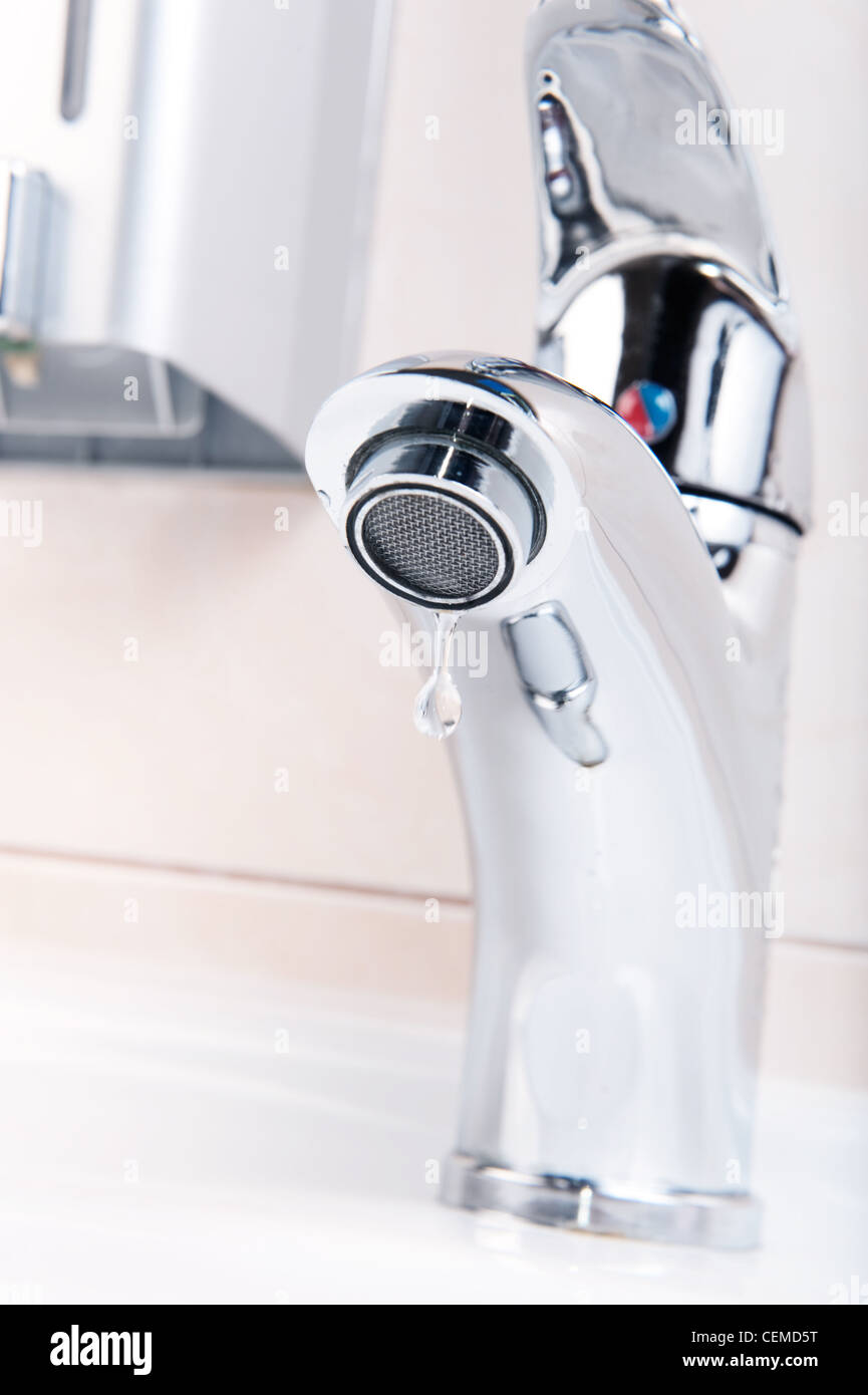 Modern faucet closeup with cute water drop Stock Photo - Alamy