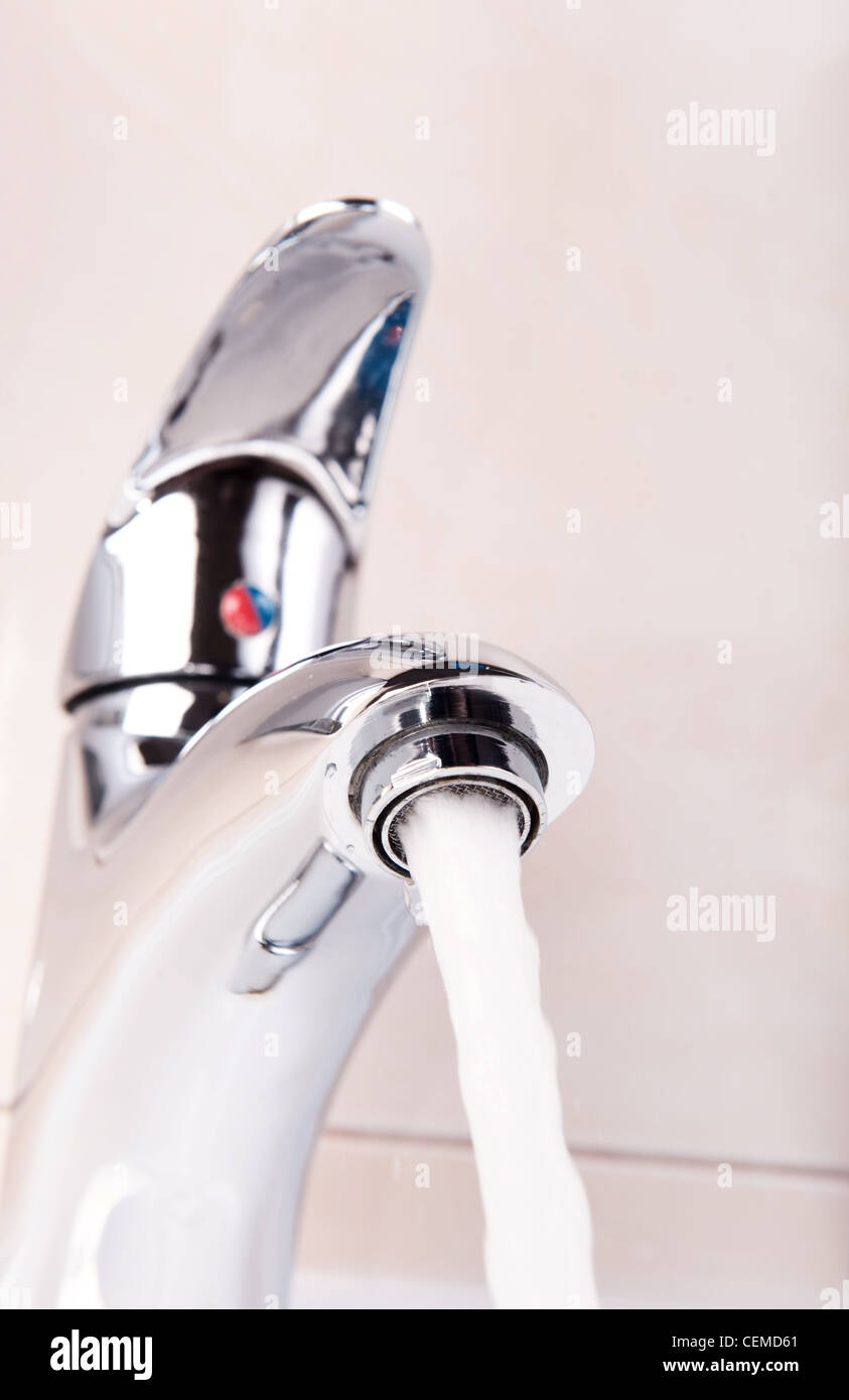 Modern Faucet closeup with streaming water flow Stock Photo - Alamy