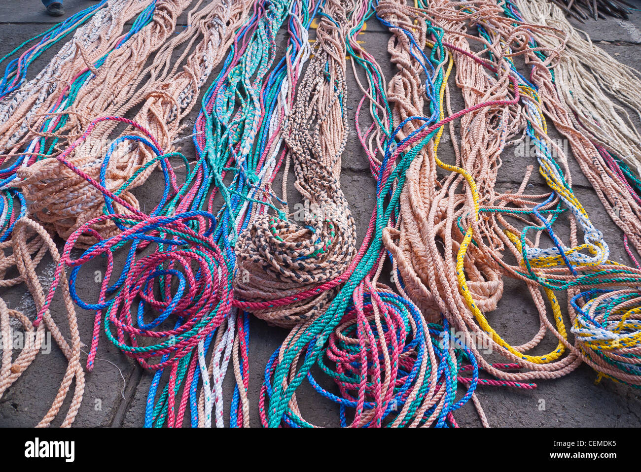Multi-colored strands of nylon rope lay on the pavement of the central ...
