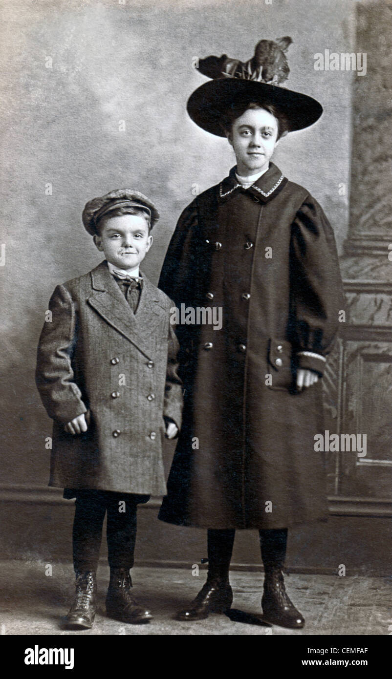 Vintage photograph of a boy and girl wearing overcoats, circa 1908 ...