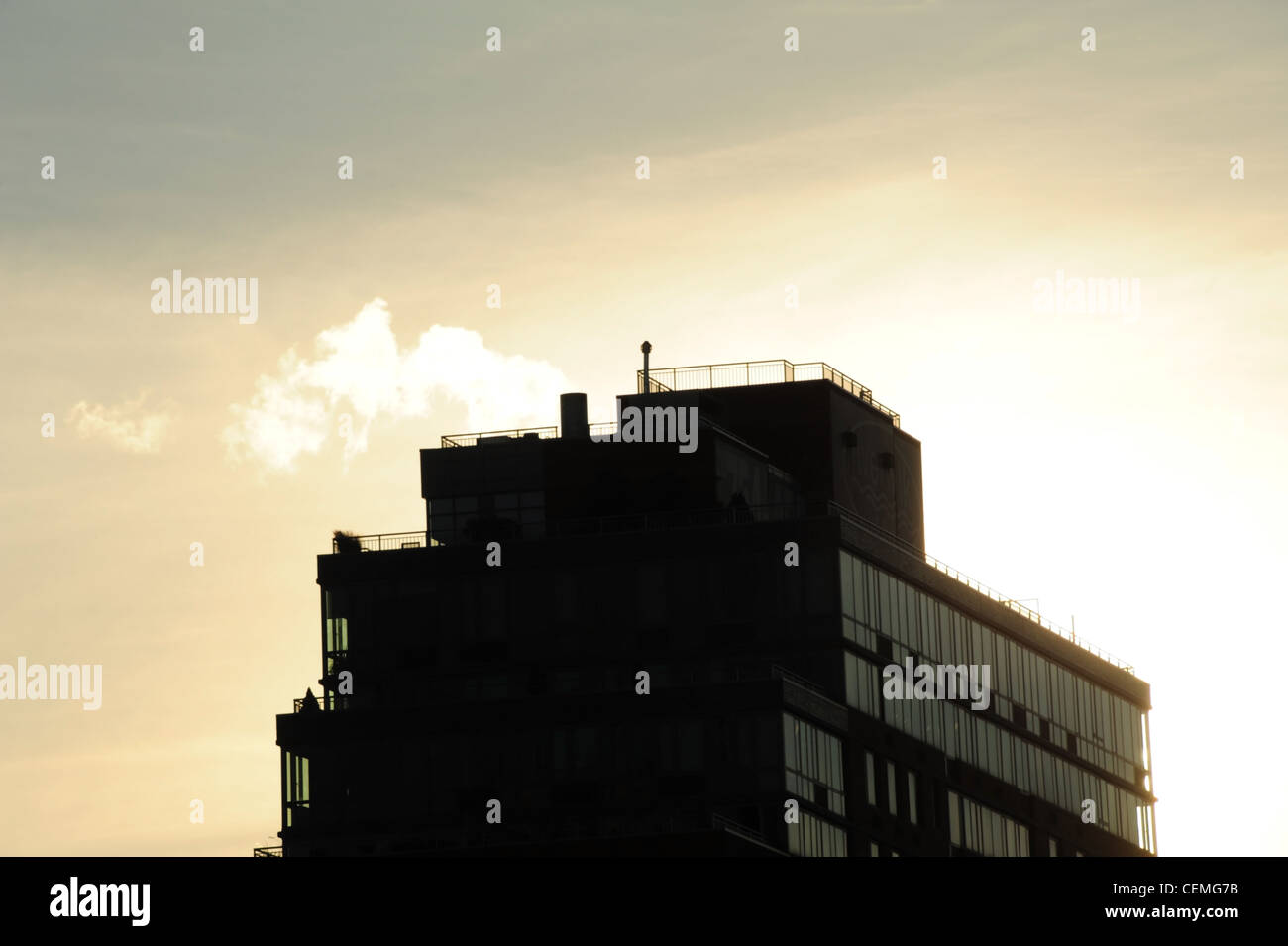 Sunrise silhouette white steam billowing from a roof chimney rising ...