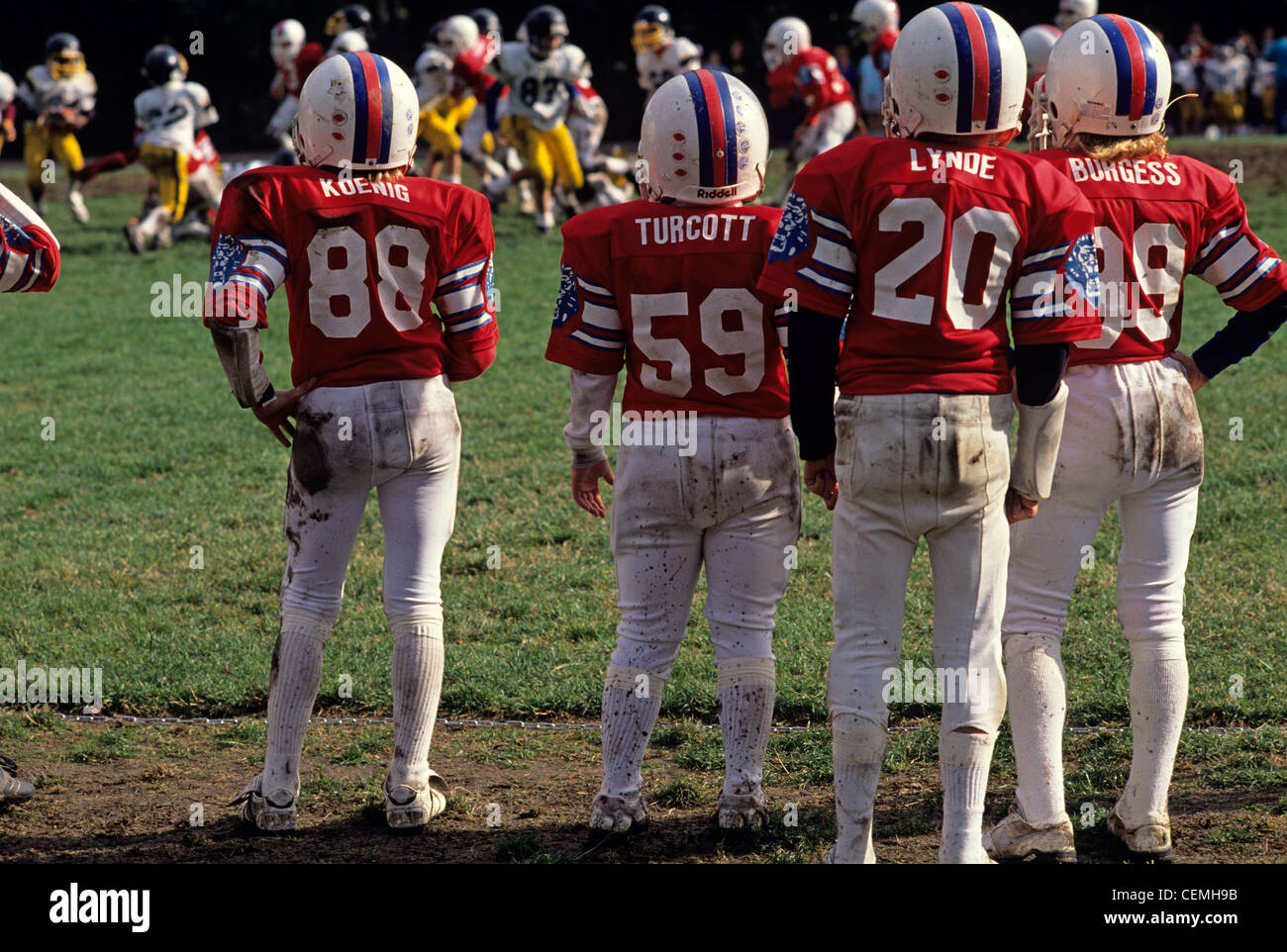 Football team along sidelines during game with backs to camera waiting ...