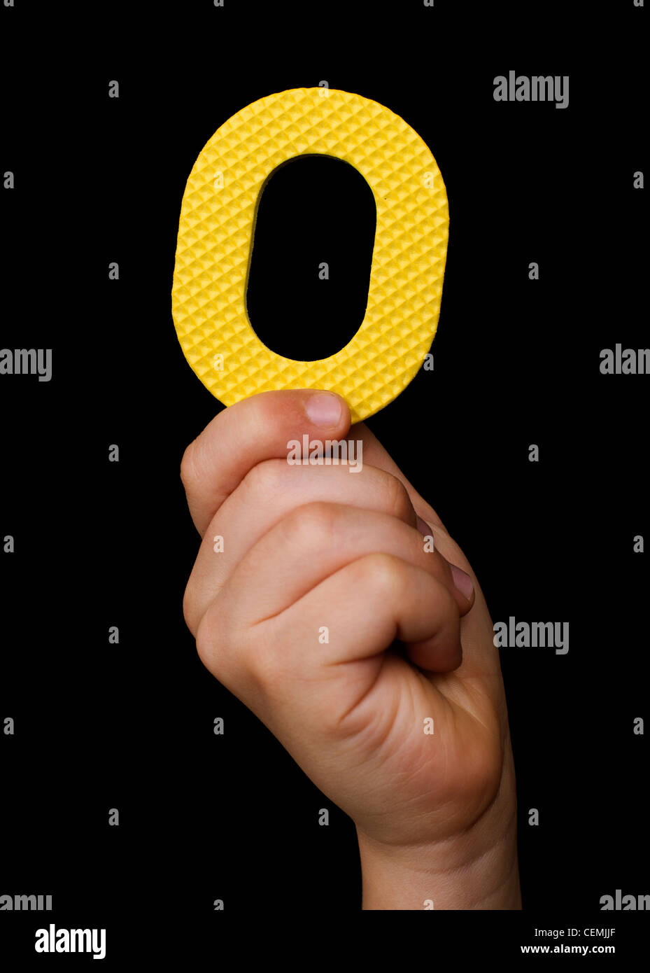 Children hand holding the number Zero. Black isolated yellow number ...