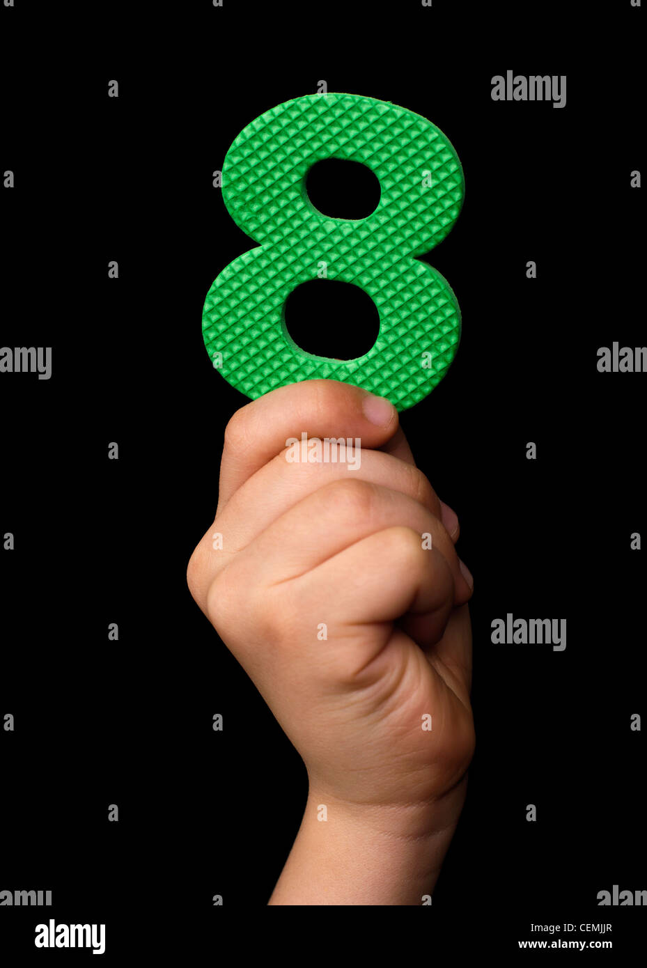 Children hand holding the number Eight. Black isolated green color ...