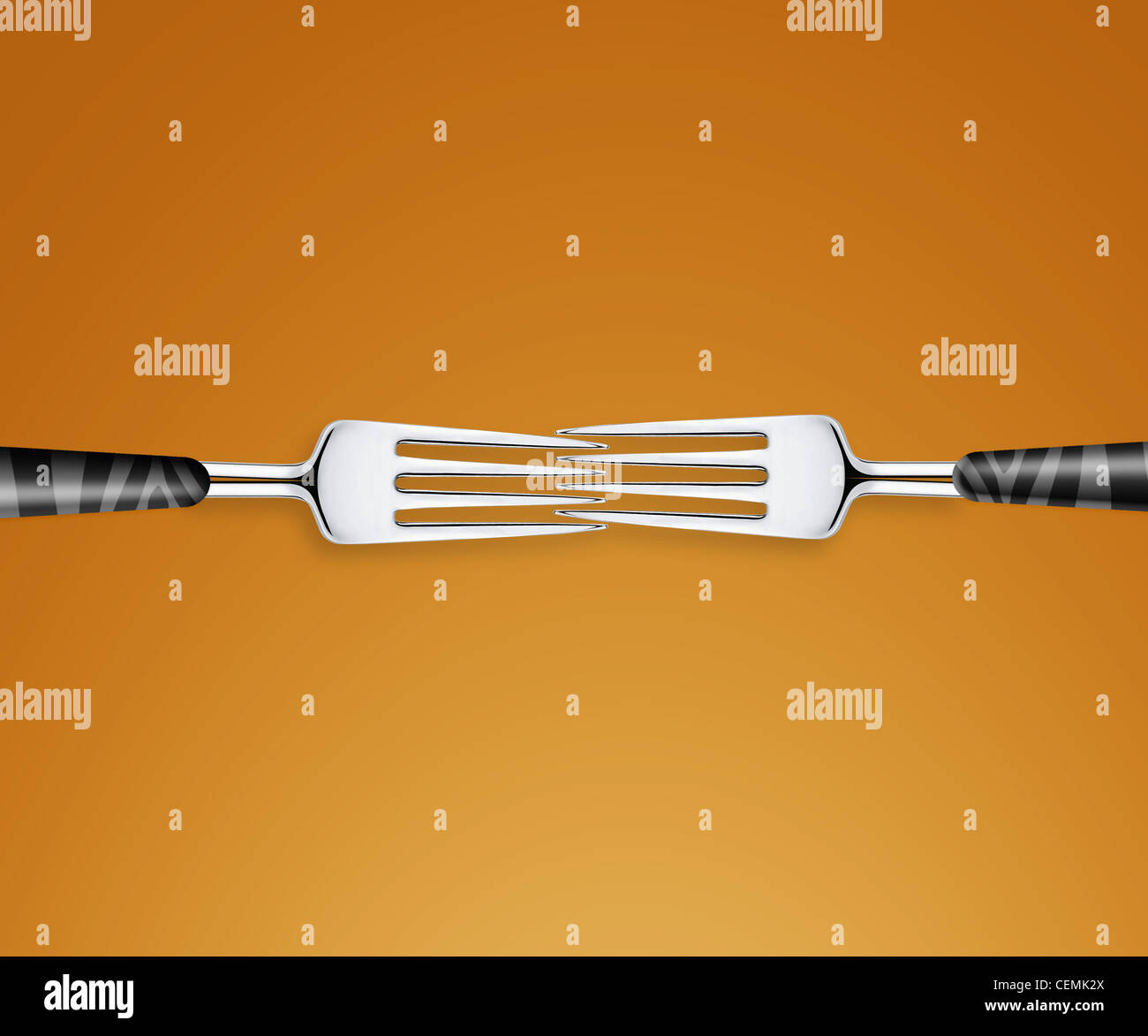two forks on orange background Stock Photo - Alamy