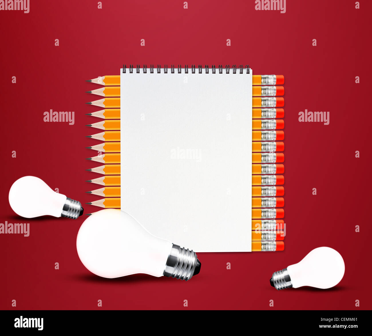 pencils and notepad and light bulb on red background Stock Photo - Alamy