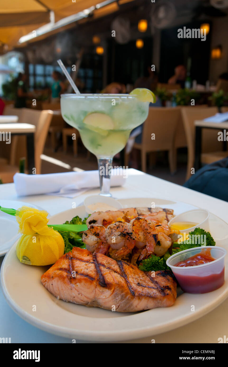 Seafood plate with fish and large Mojito cocktail on Ocean Drive Miami ...