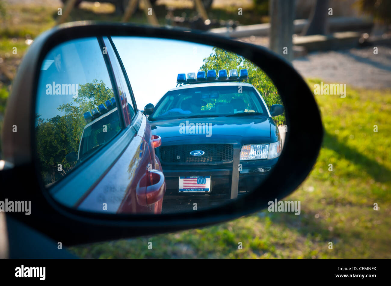 Police Ford car in side mirror Stock Photo - Alamy