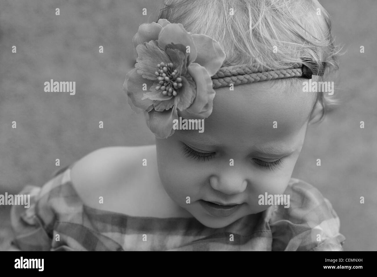 A portrait of a small pretty girl with the flower Stock Photo - Alamy