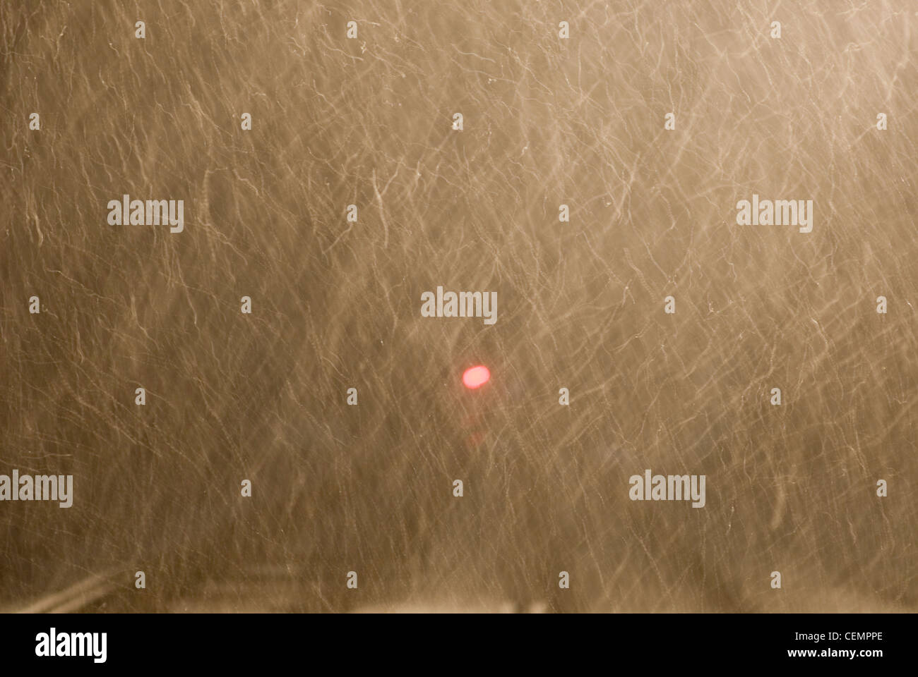 snowfall on train tracks with red light in the distance Stock Photo - Alamy