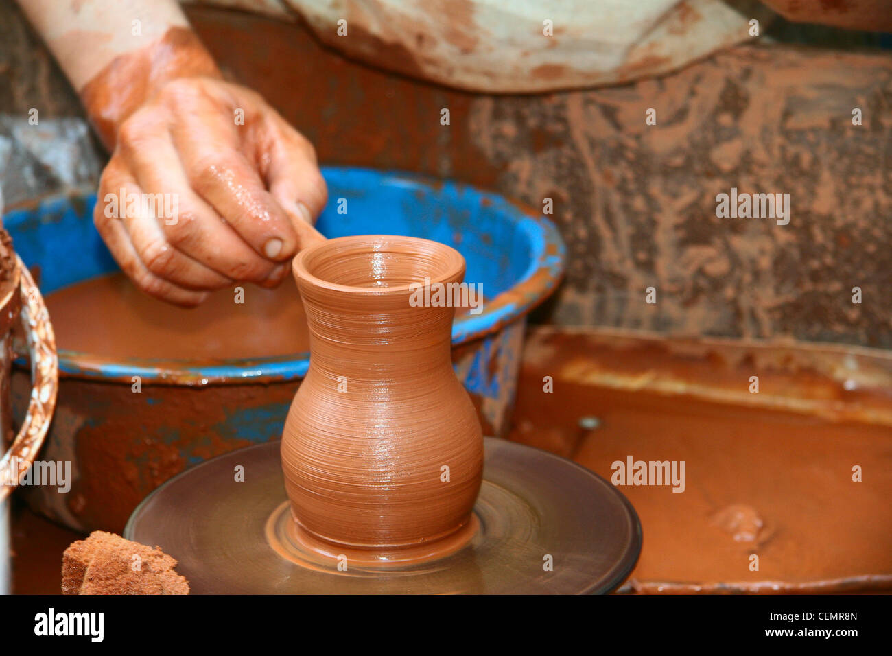 Potter shaping a ceramic jar on a pottery wheel Stock Photo - Alamy
