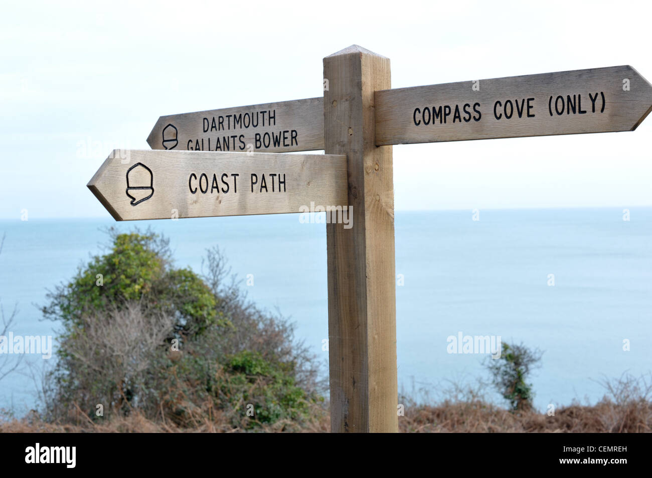 Wooden sign post along the South West Coast Path with directions to ...