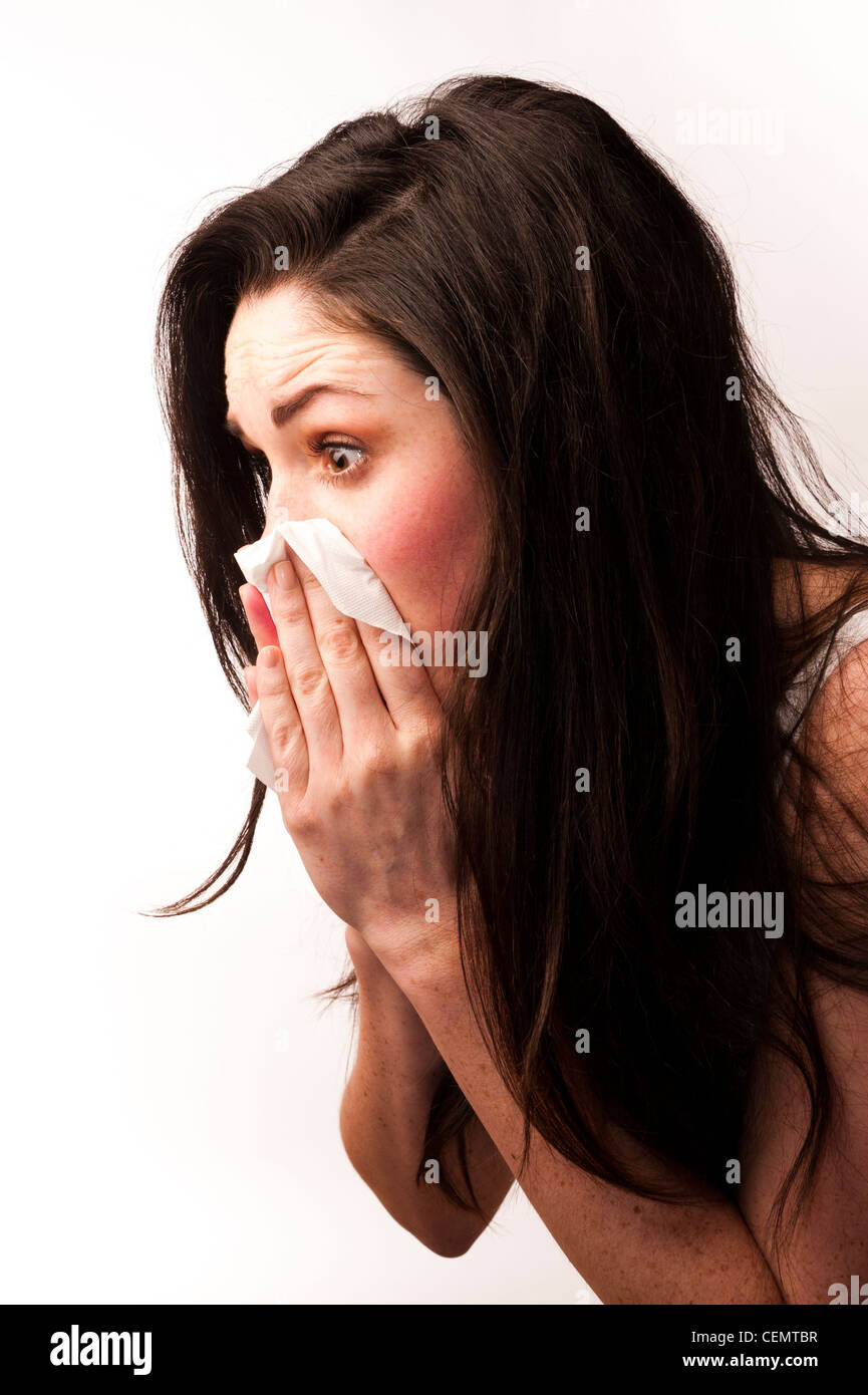 A young woman with brown hair and eyes feeling ill suffering from a ...
