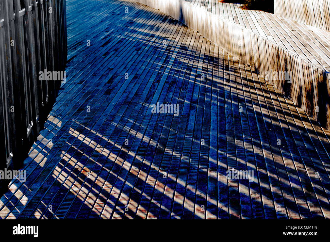 Cast Shadow,Light though fence casts shadow onto wooden floor slats ...