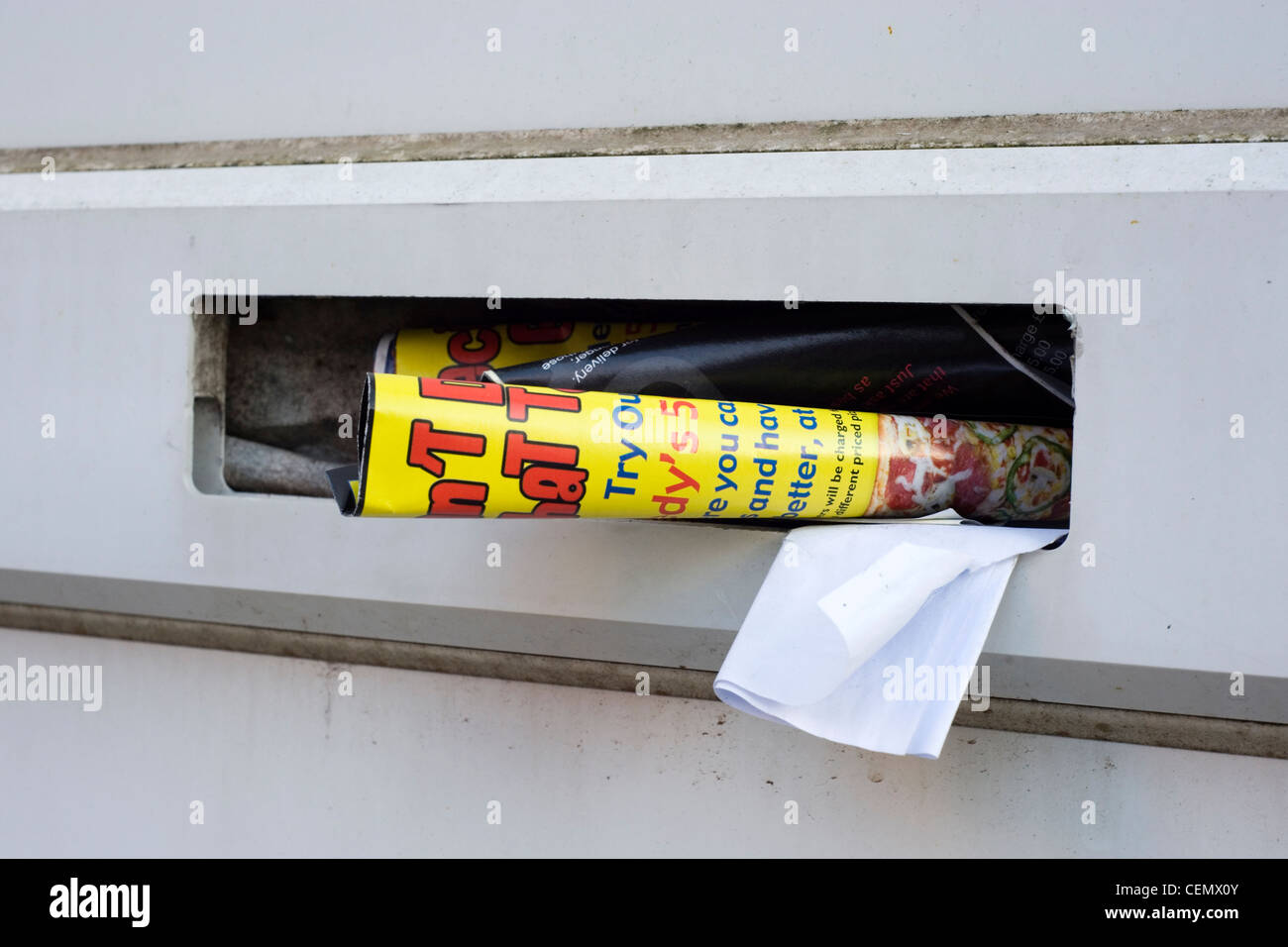 junk mail stuffed into a letter box Stock Photo - Alamy