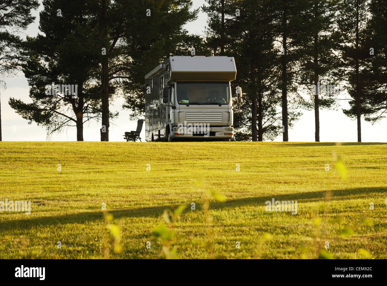 Mobile home on camping site into the sunset Stock Photo - Alamy