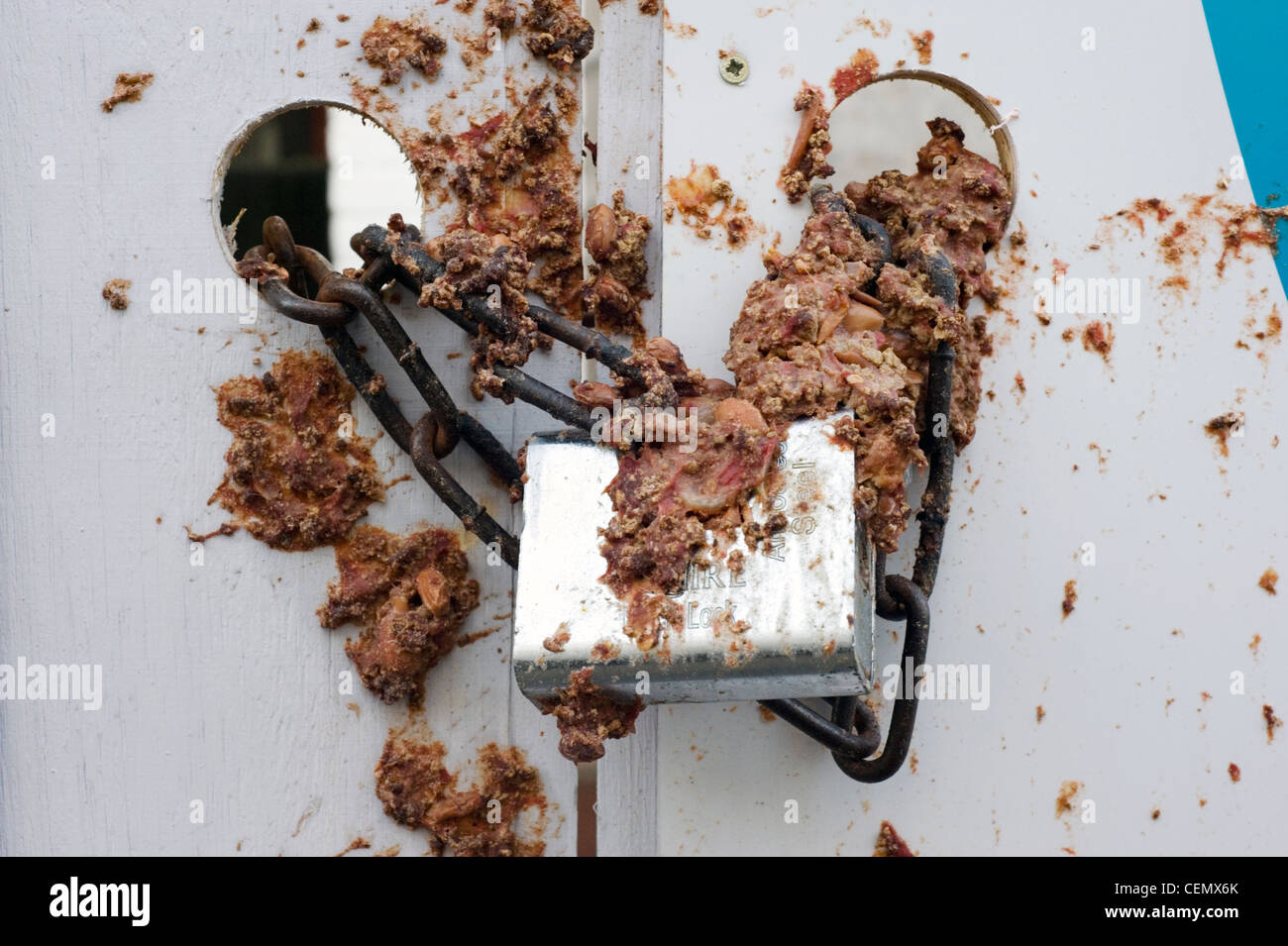 remains of a takeaway meal smeared over a padlock and door Stock Photo ...