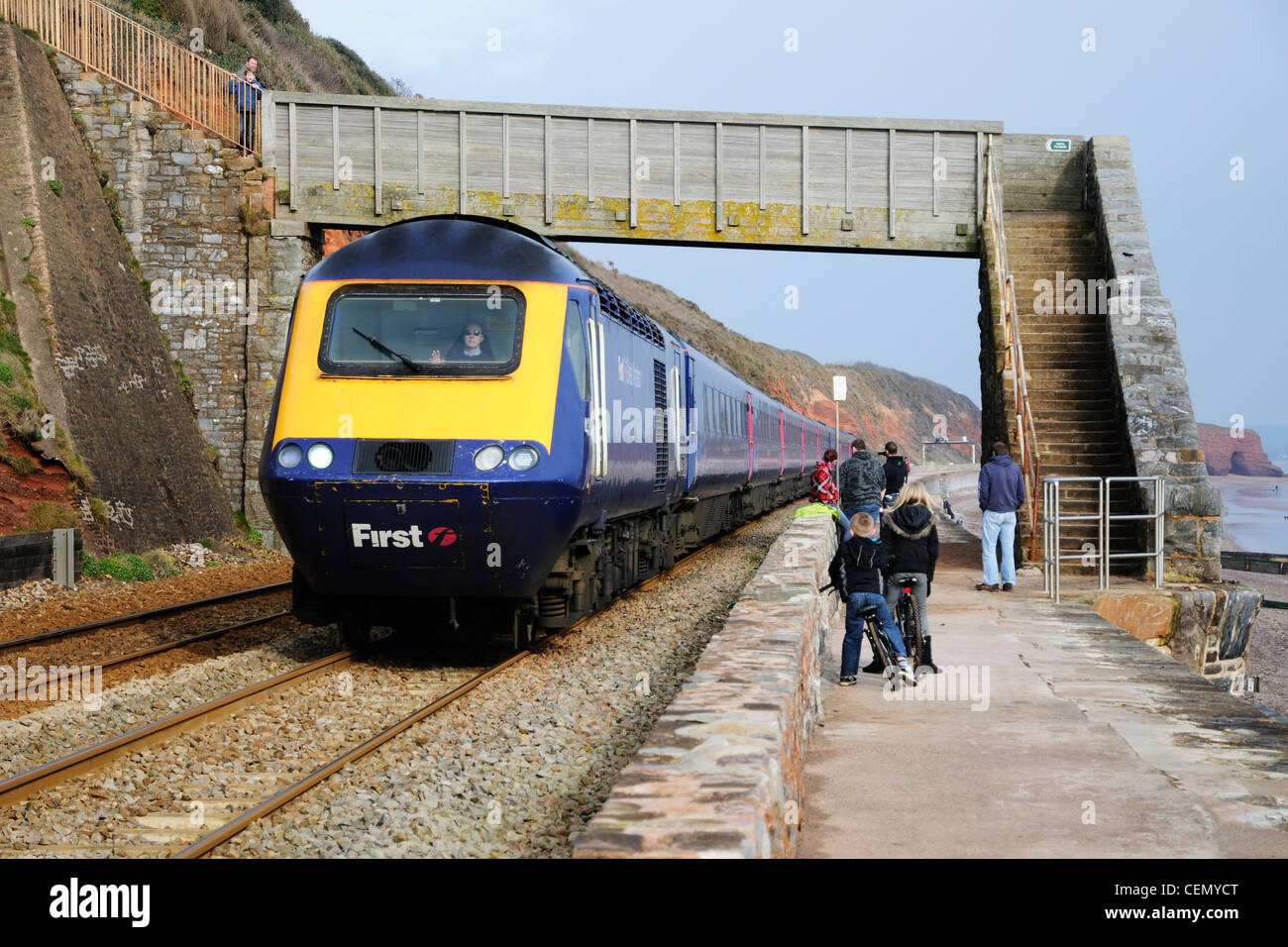First Great Western HST train passes a group of young people on the sea ...