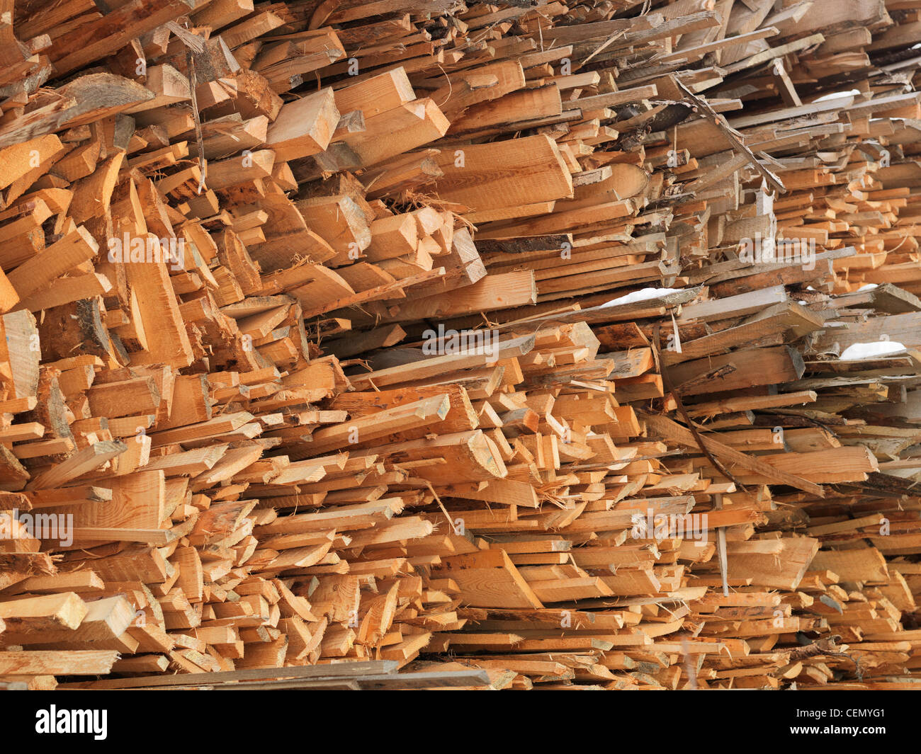 Wood stacked up building interesting structures, small areas snow ...