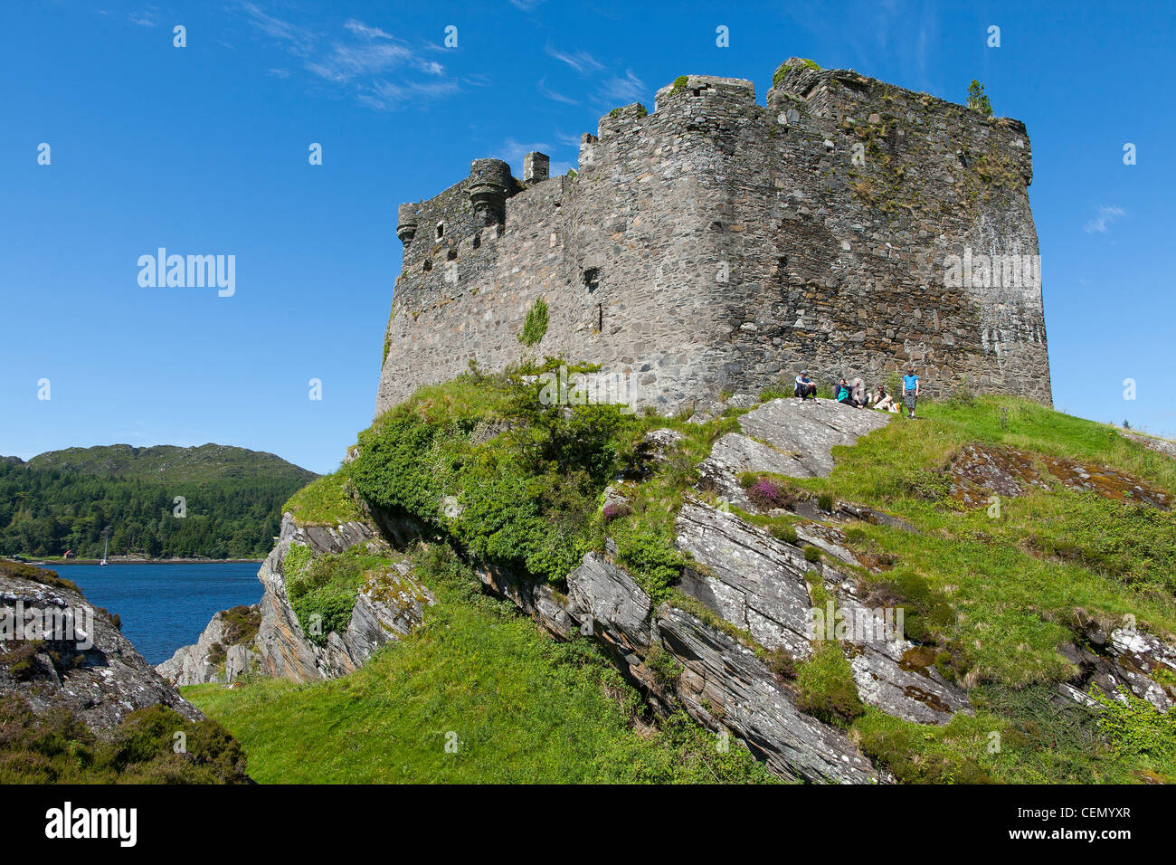 Visitors walk down from Castle Tioram, the traditional seat of the Clan ...