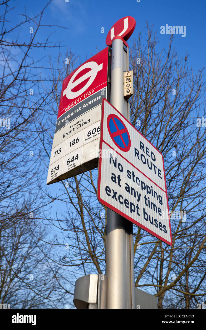 Bus stop and traffic red route sign, England, UK Stock Photo - Alamy