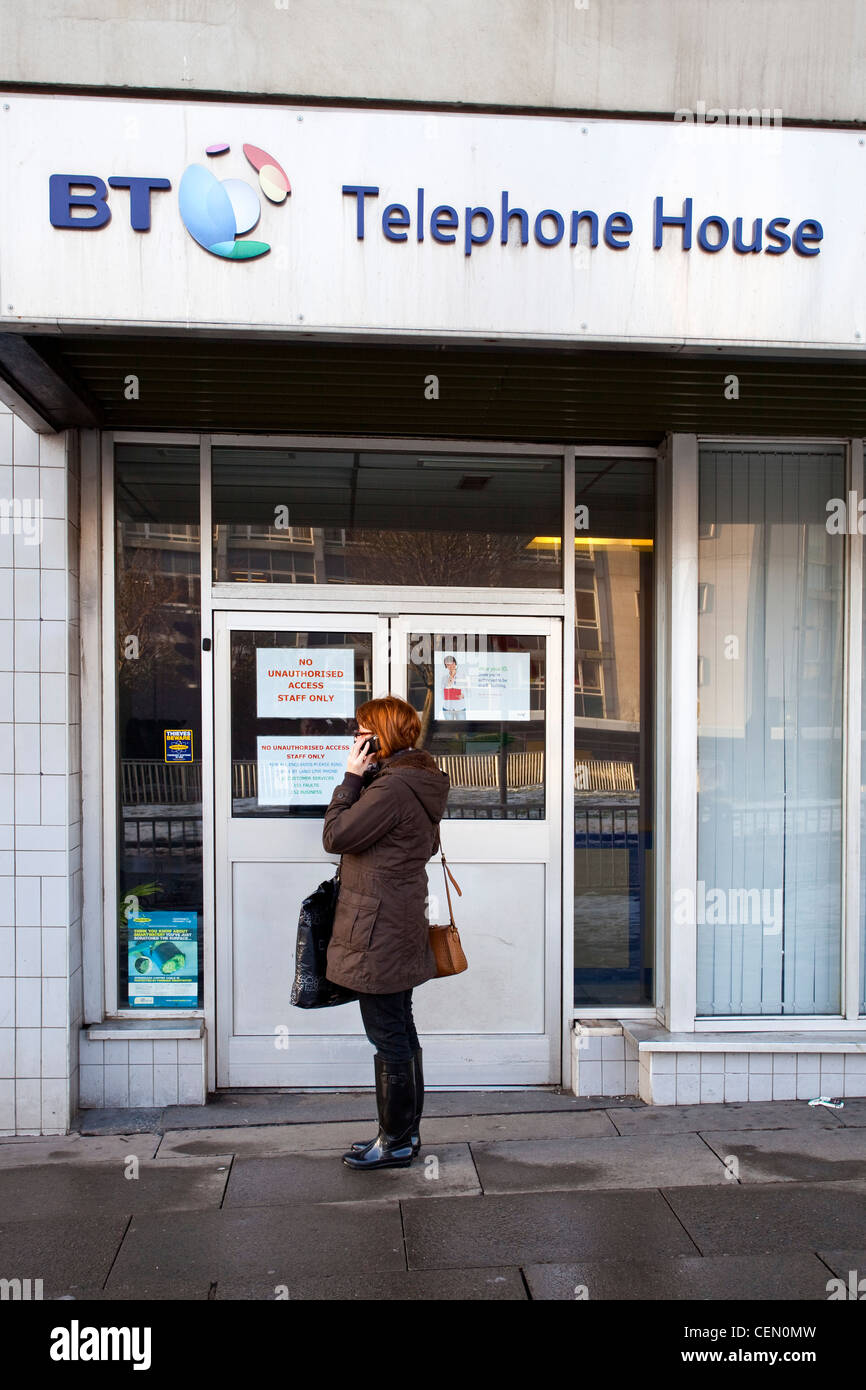 A woman using a mobile phone outside Telephone House in Sheffield South ...