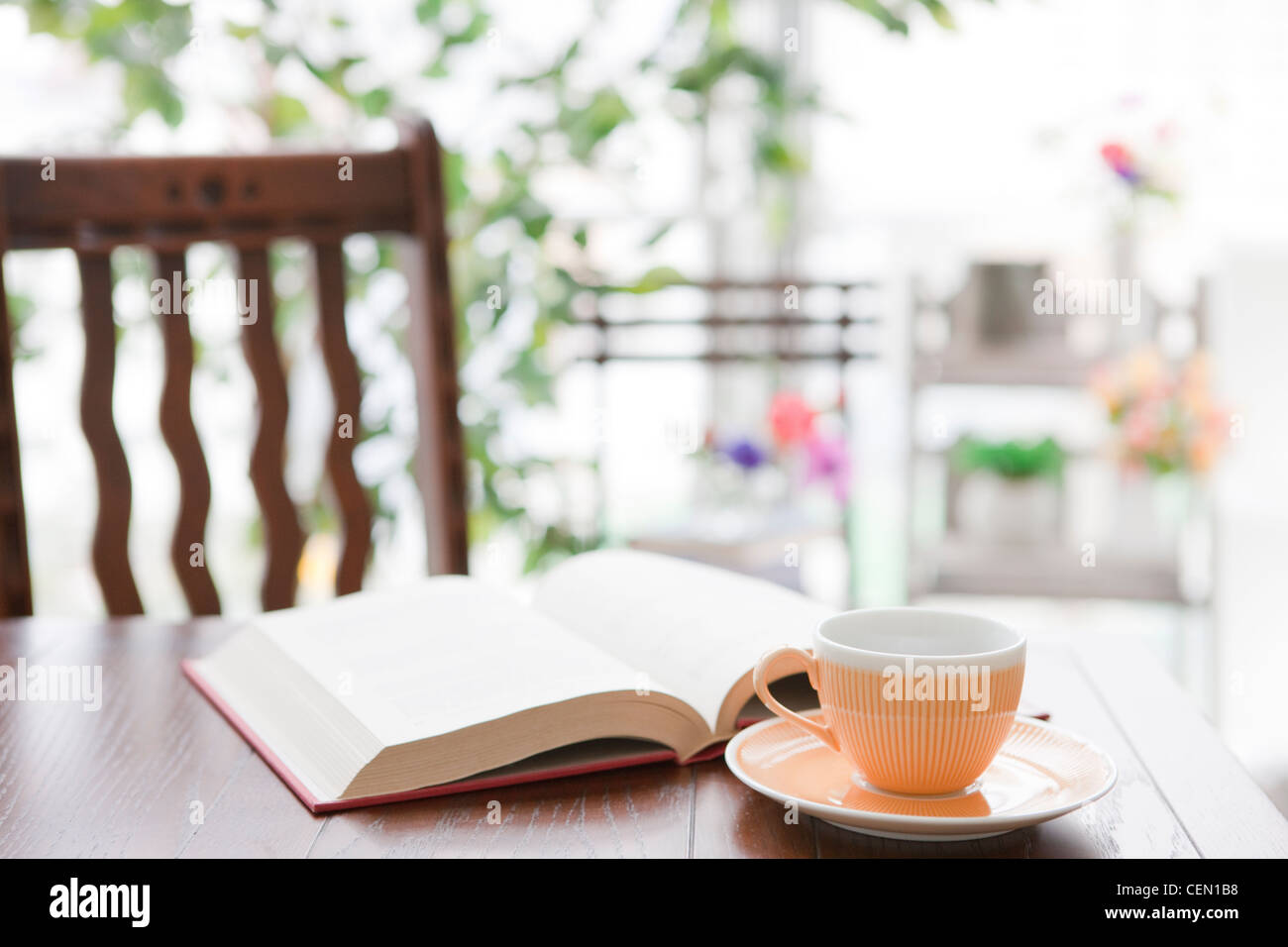 Book and cup on the table Stock Photo - Alamy