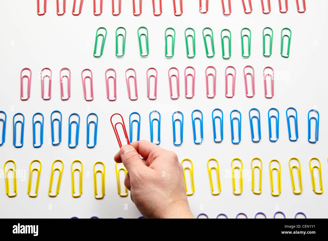 Hand holding paper clips Stock Photo - Alamy