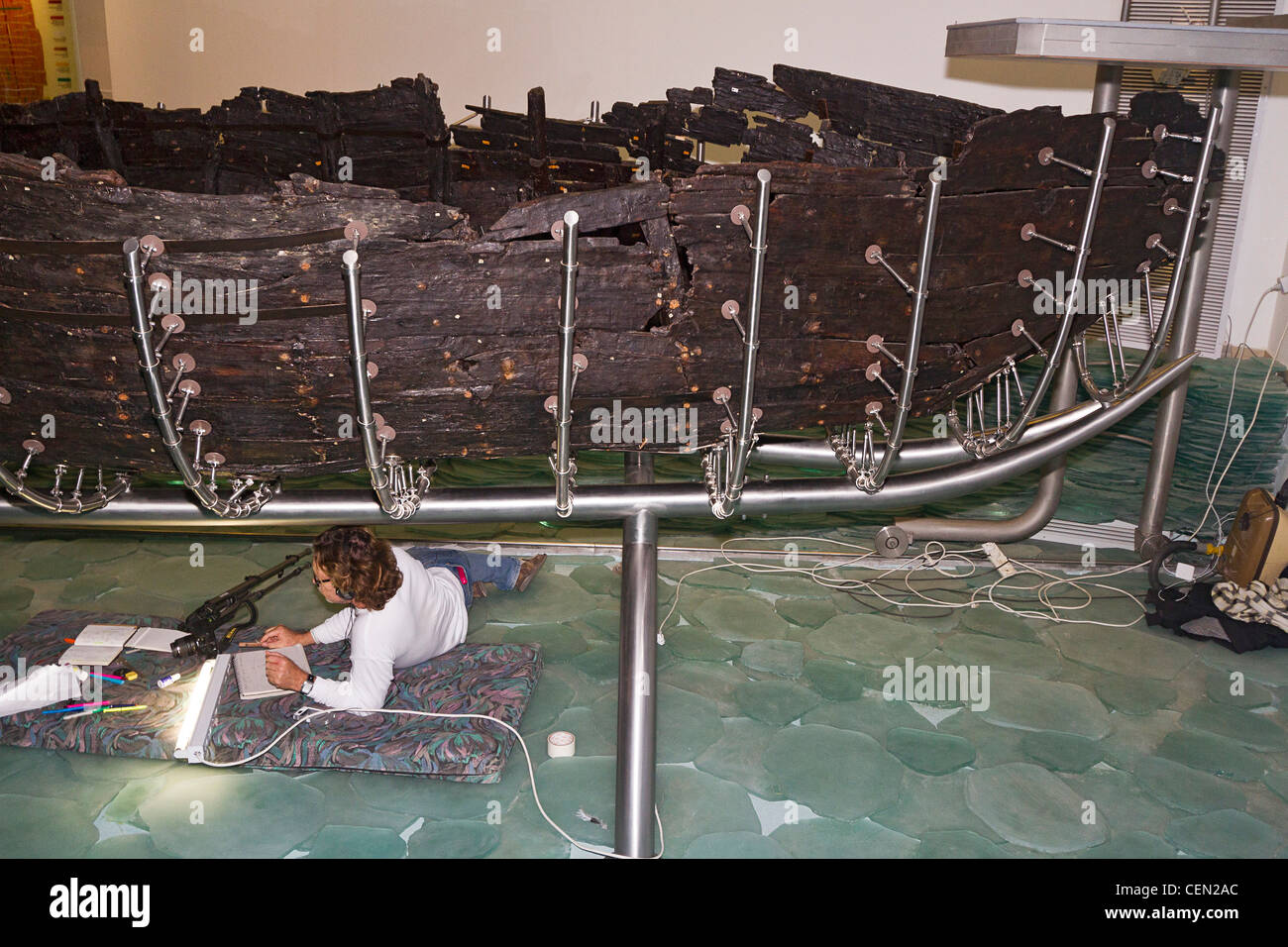 Researcher with ancient Galilee boat at the Yigal Allon Centre (Jesus ...