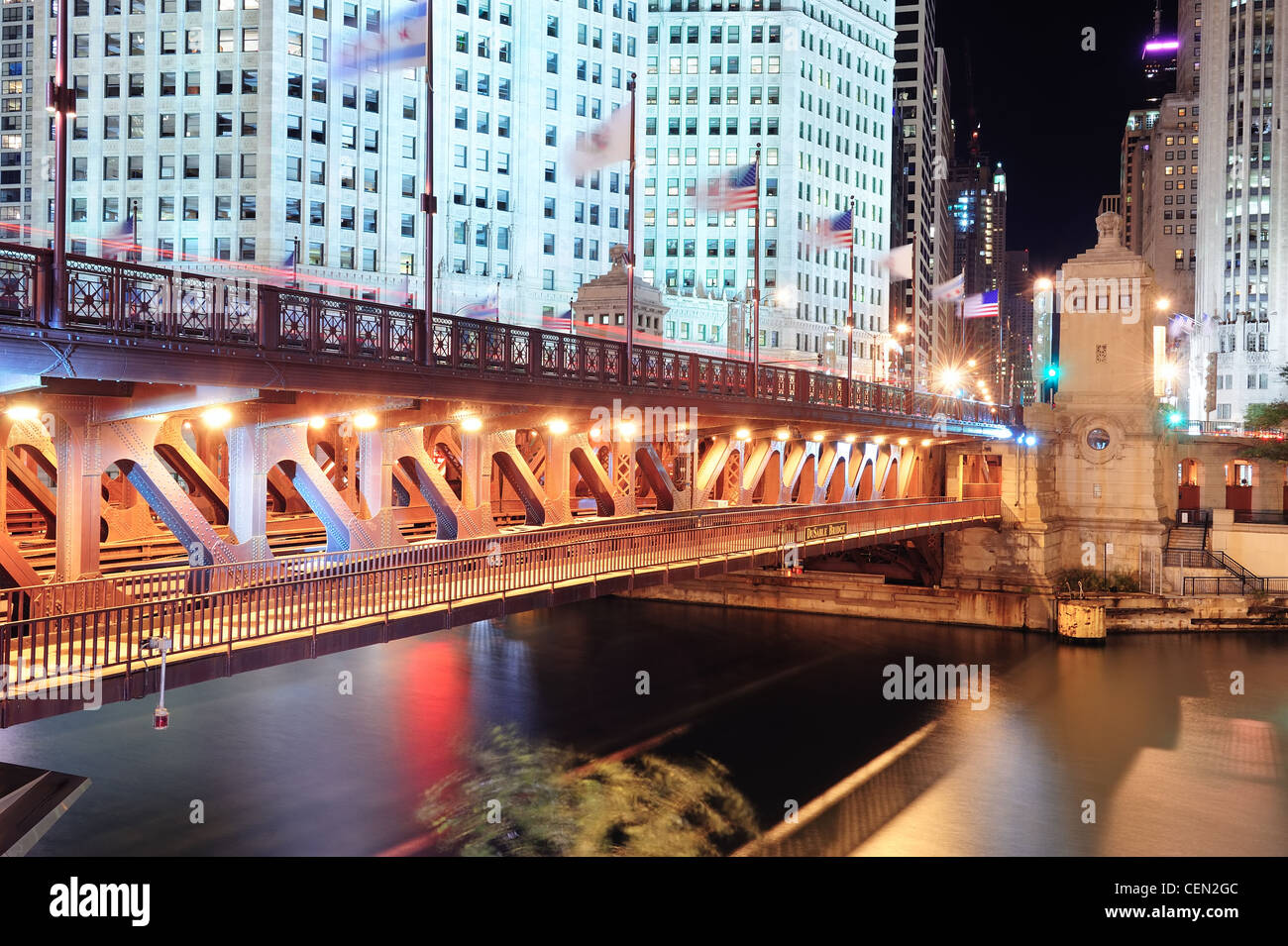 Chicago River Walk with urban skyscrapers and bridge illuminated with ...