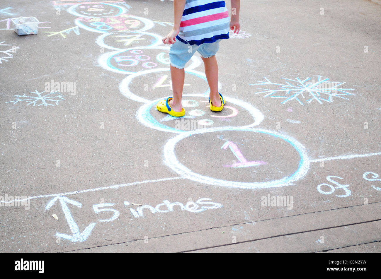 Kid playing Engklek on a street side Stock Photo - Alamy