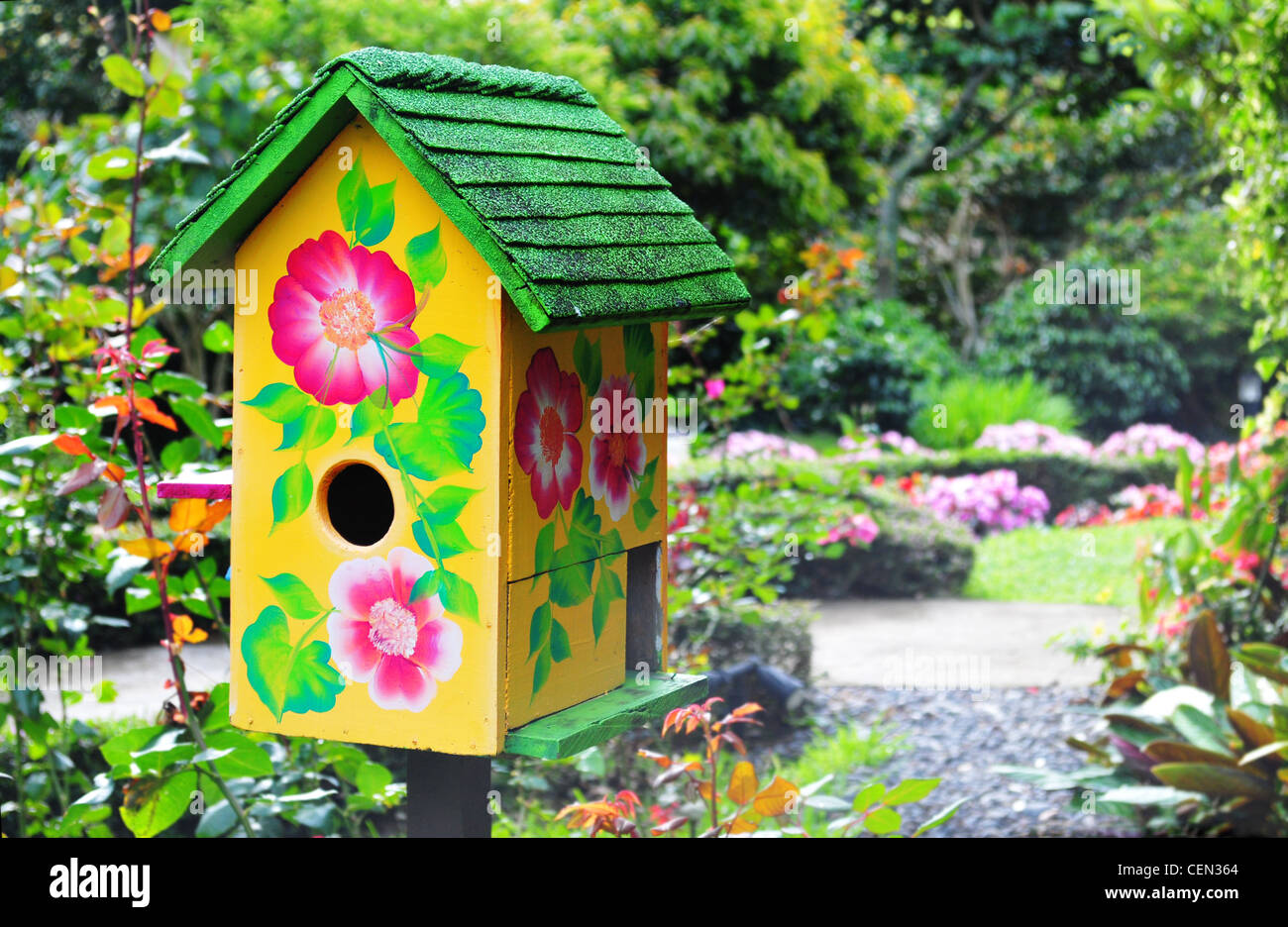 Beautiful bird house in a lush garden Stock Photo - Alamy