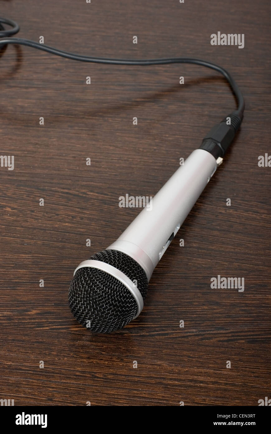 The microphone on a brown wooden background Stock Photo - Alamy