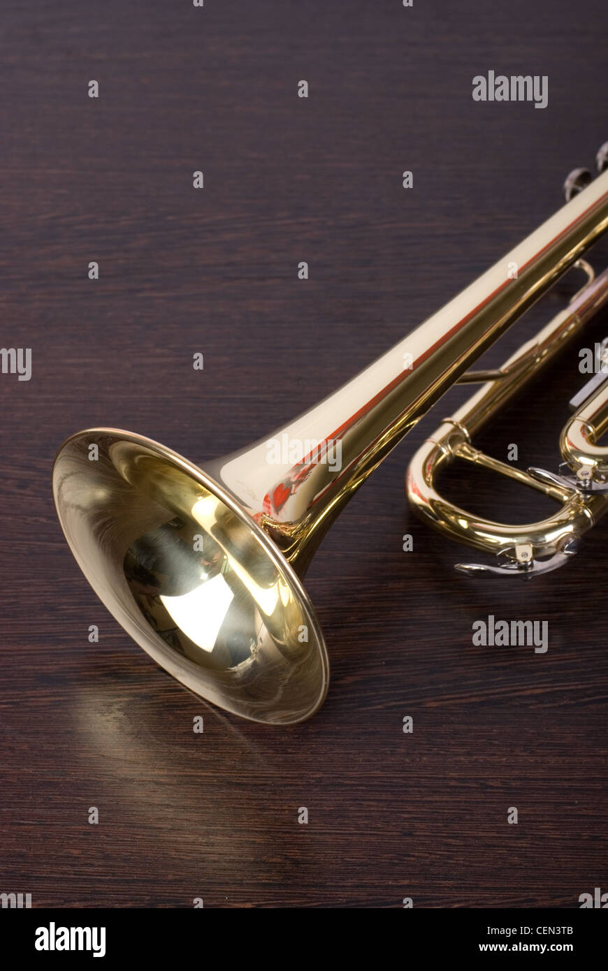 trumpet closeup on brown wooden background Stock Photo - Alamy